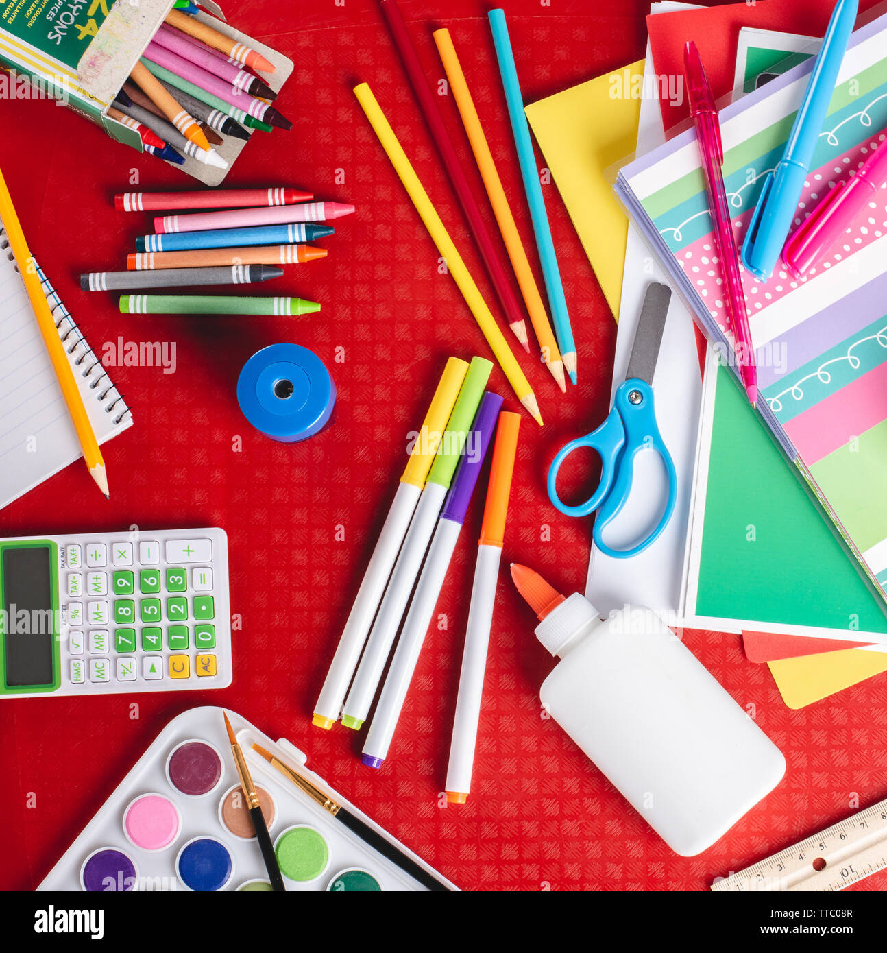 Overhead view of an assortment of colorful school supplies on a childs ...