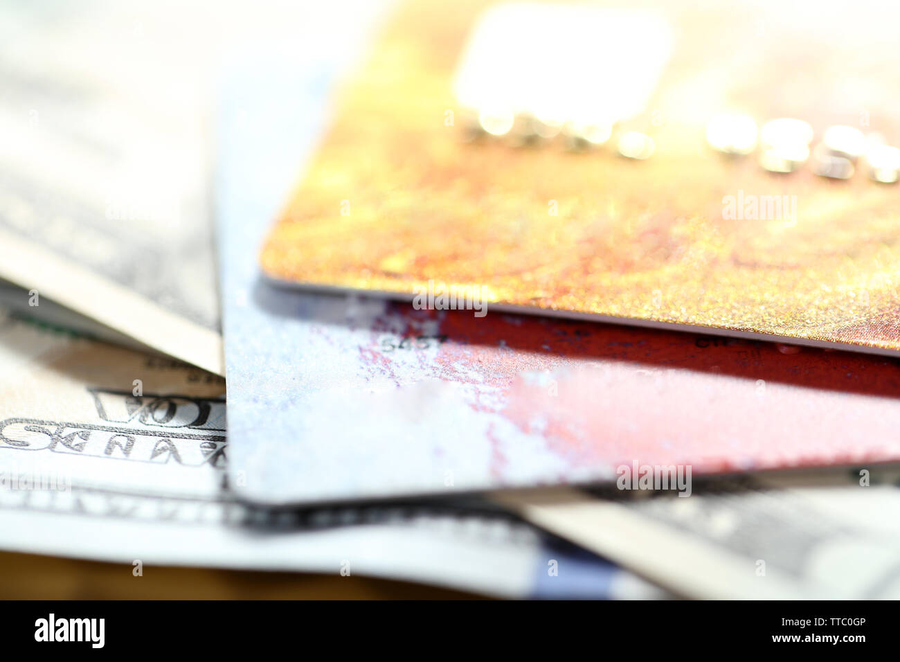 Credit cards and dollars on golden background Stock Photo - Alamy