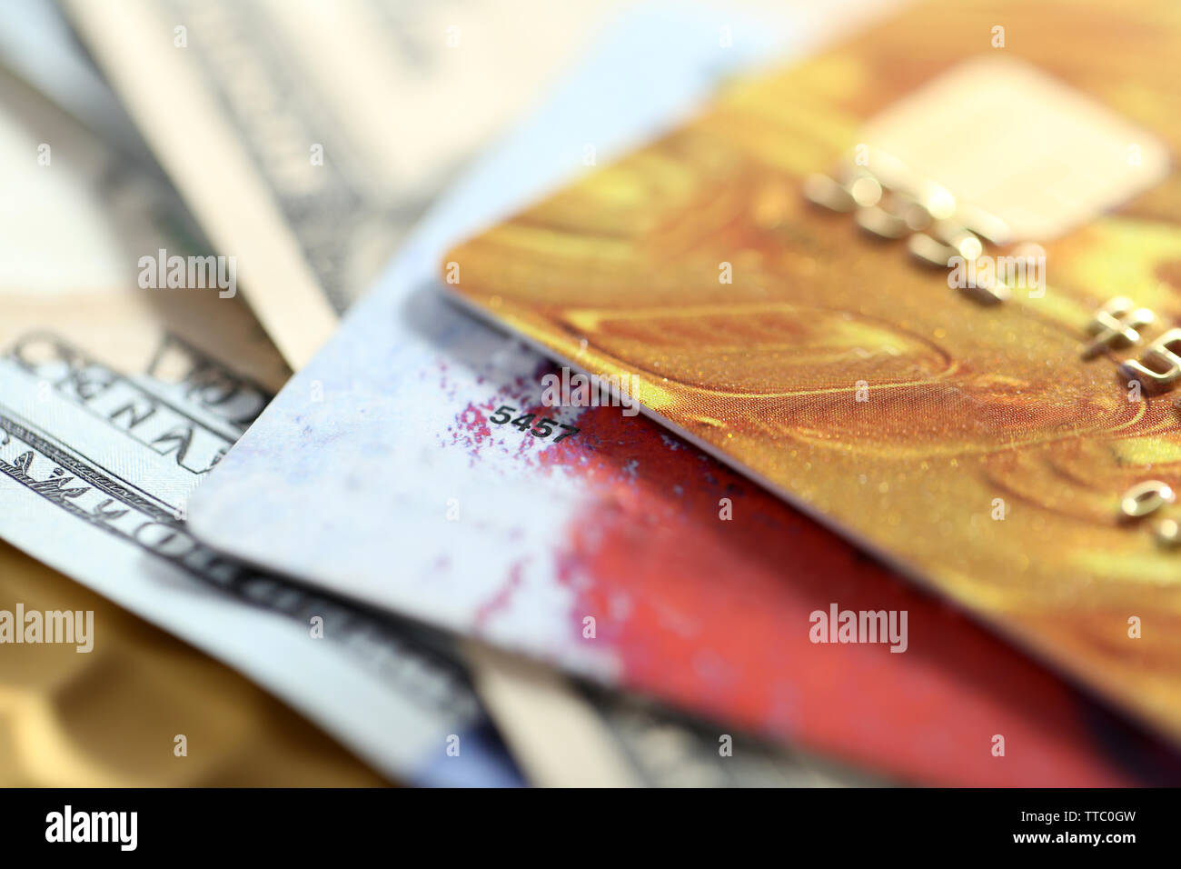 Credit cards and dollars on golden background Stock Photo - Alamy
