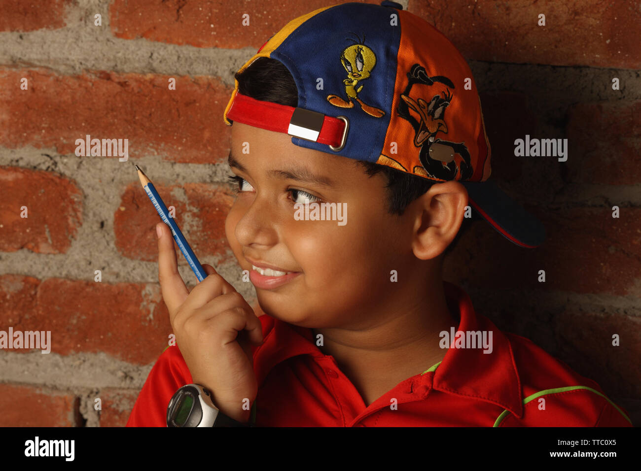 Boy holding a pencil Stock Photo - Alamy
