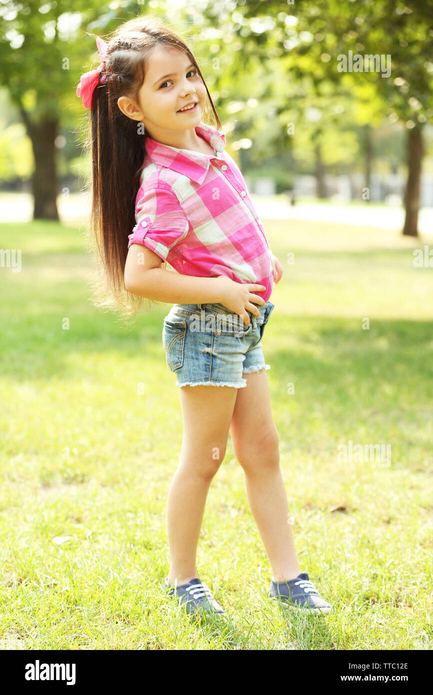 Happy little girl in the park Stock Photo - Alamy
