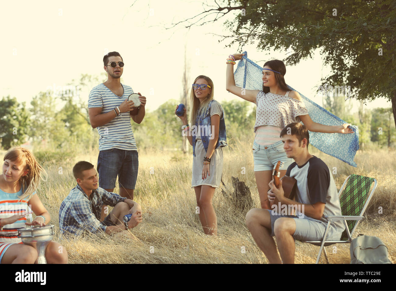Young hippie people relaxing in the forest outdoors Stock Photo - Alamy