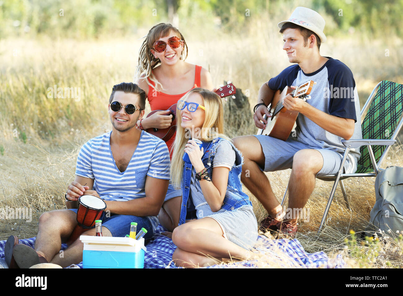Young hippie people relaxing in the forest outdoors Stock Photo - Alamy
