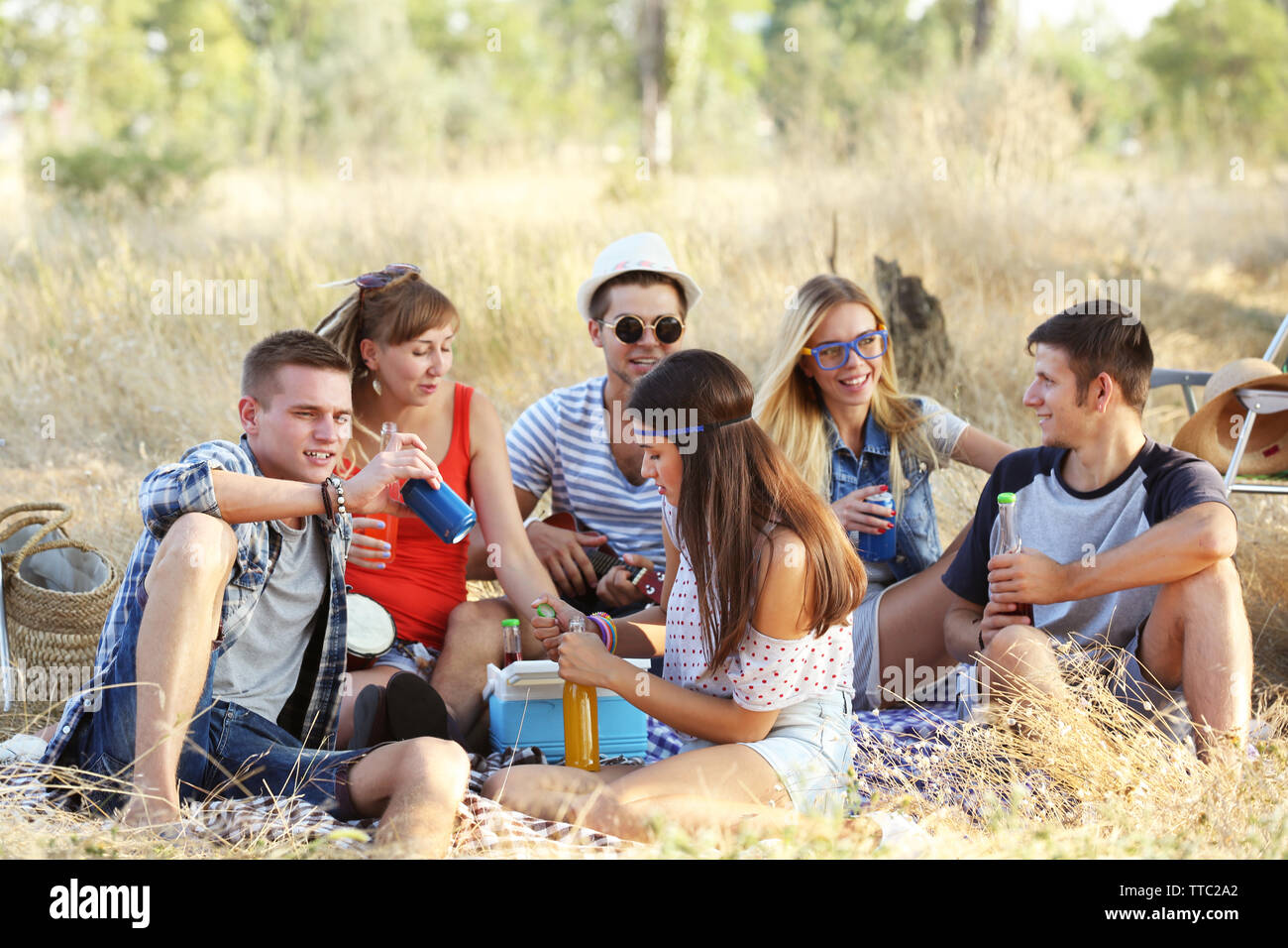 Young hippie people relaxing in the forest outdoors Stock Photo - Alamy