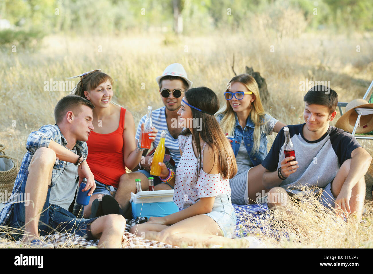 Young hippie people relaxing in the forest outdoors Stock Photo - Alamy