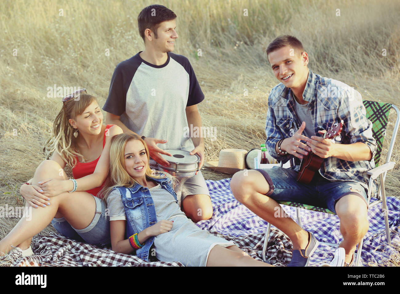 Joyful smiling friends relaxing in the forest outdoors Stock Photo - Alamy