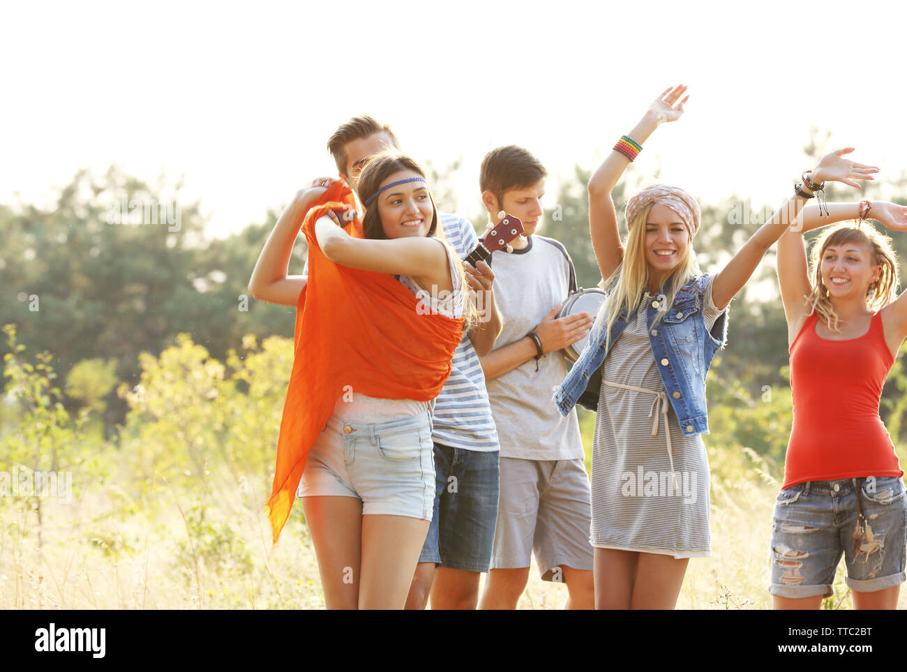 Joyful smiling friends dancing in the forest outdoors Stock Photo - Alamy