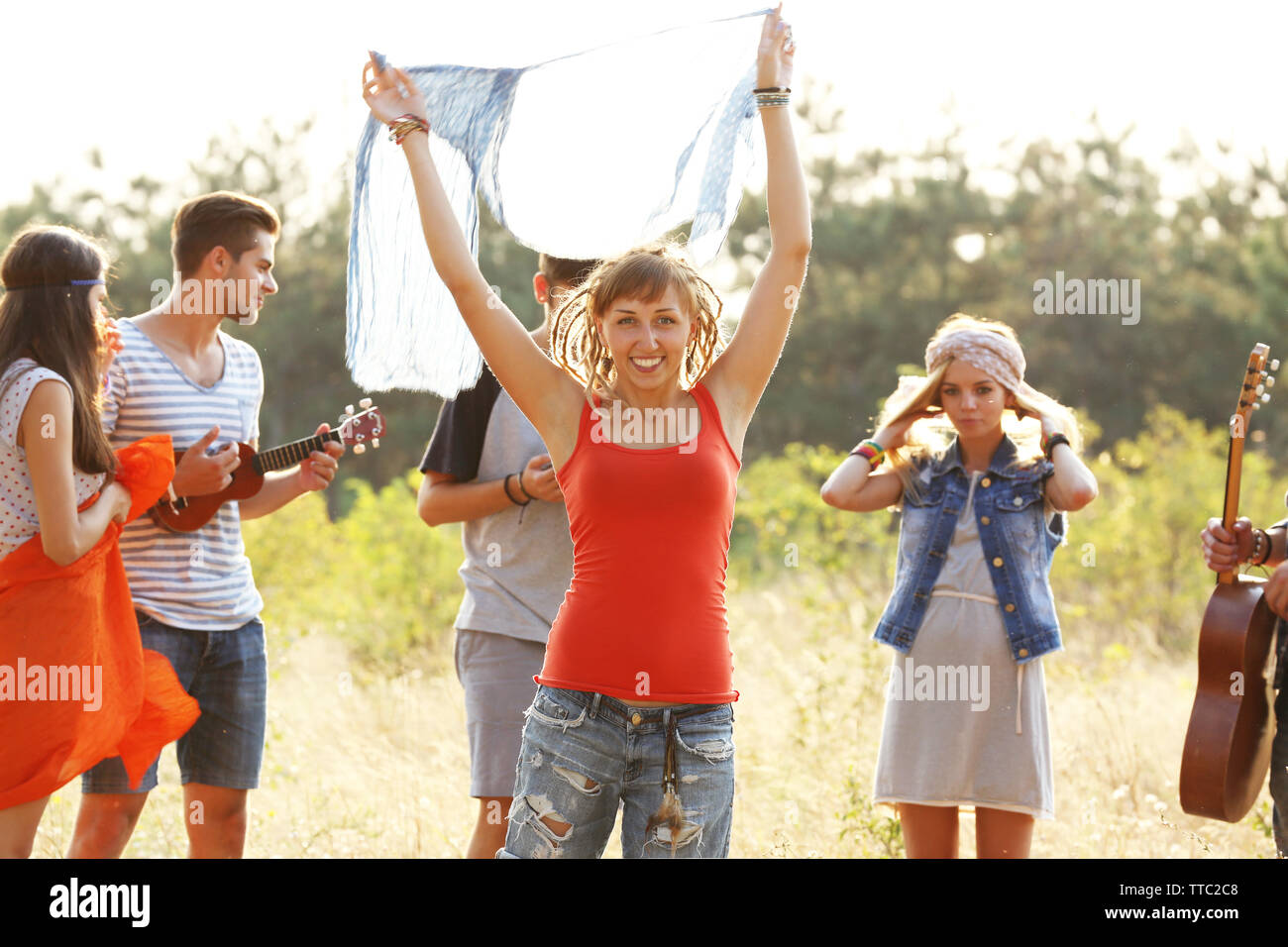 Joyful smiling friends having fun in the forest outdoors Stock Photo ...