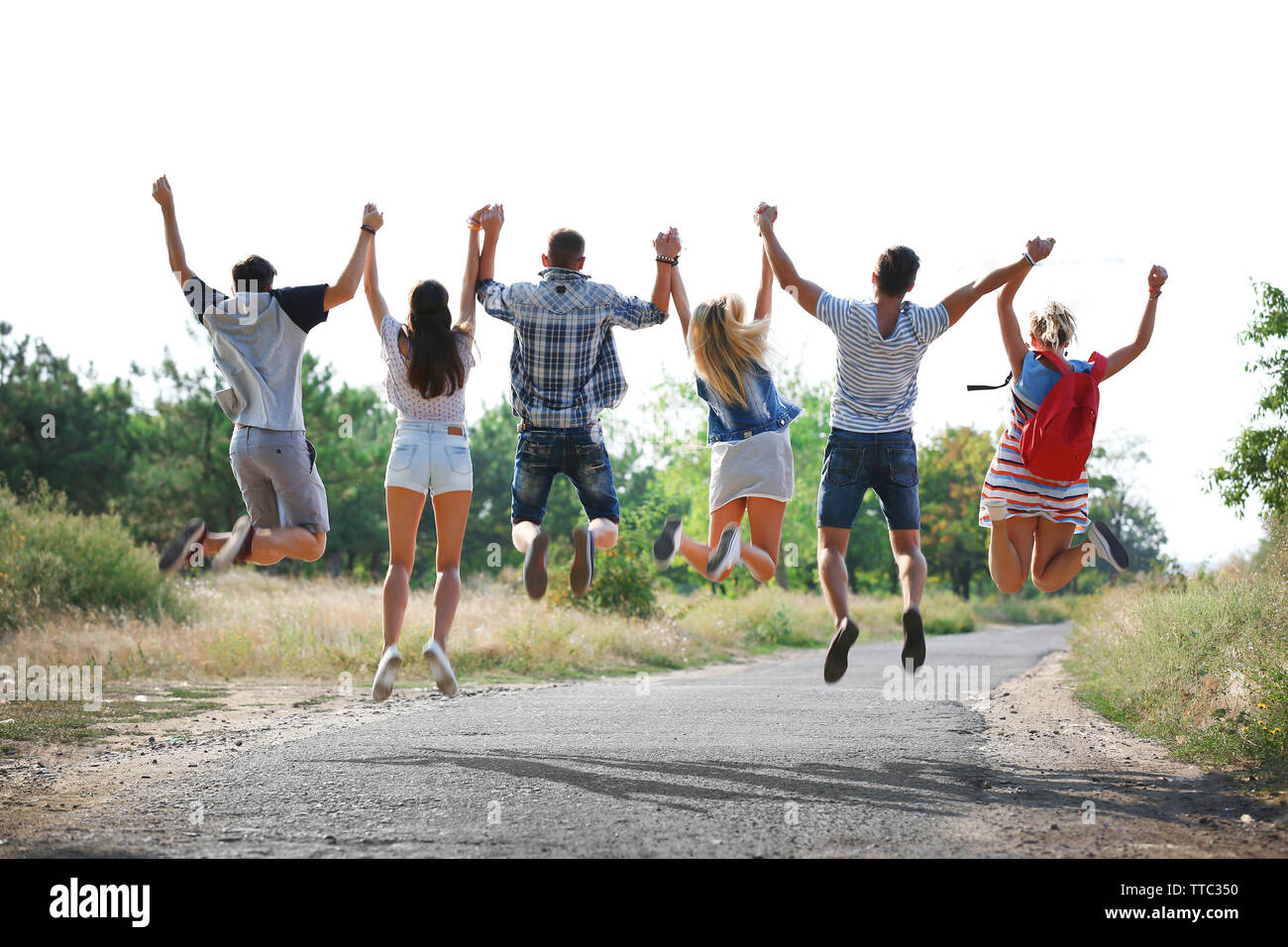 Happy friends jumping together, outdoors Stock Photo - Alamy