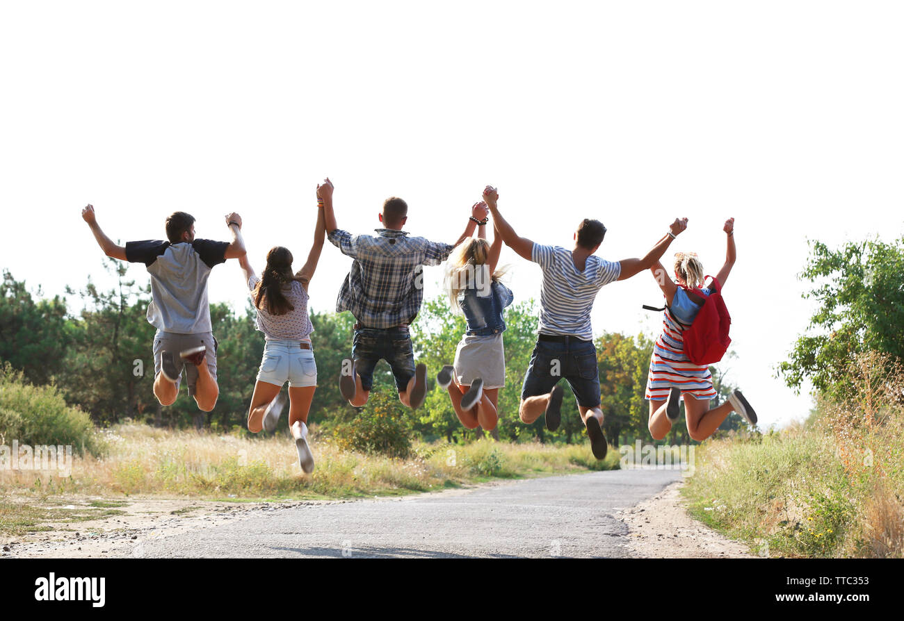 Happy friends jumping together, outdoors Stock Photo - Alamy
