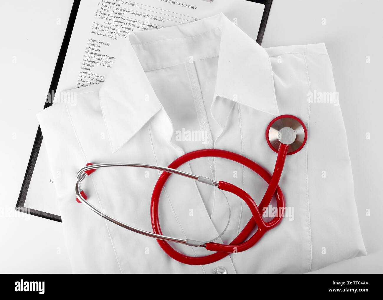 Stethoscope, medical record and uniform on white background Stock Photo ...