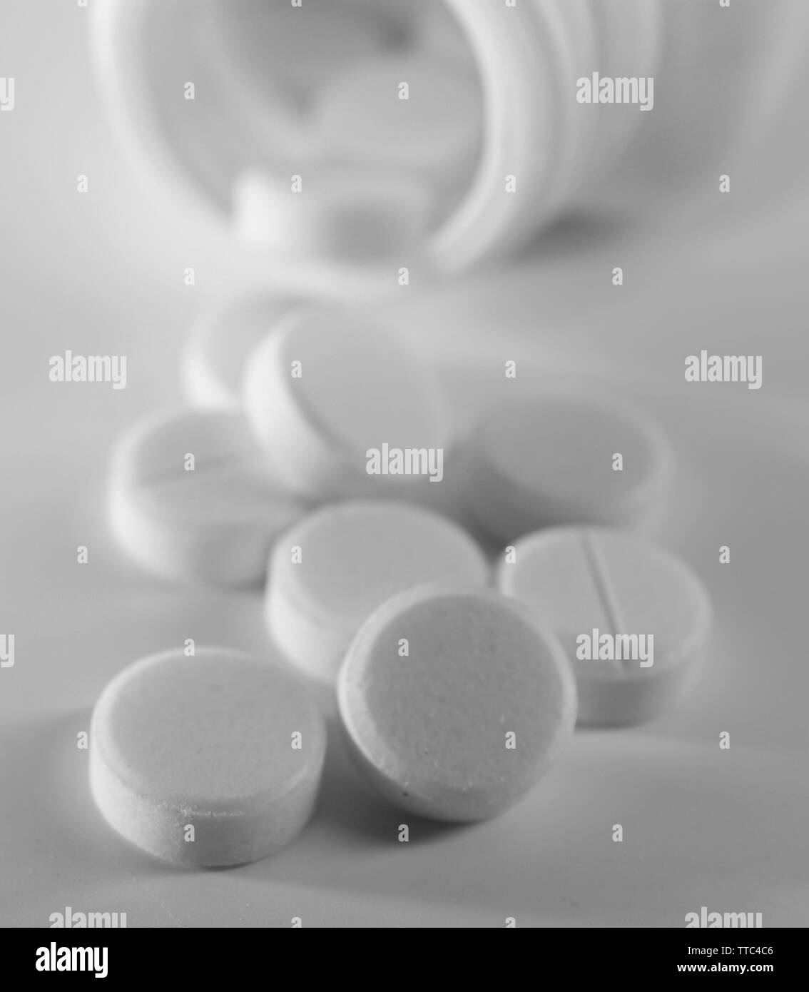 Blue drugs spilled from pill bottle on white background, close up Stock ...