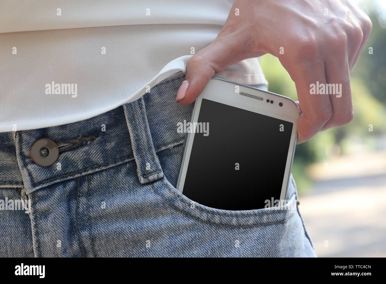 White smart mobile phone in jeans pocket Stock Photo - Alamy
