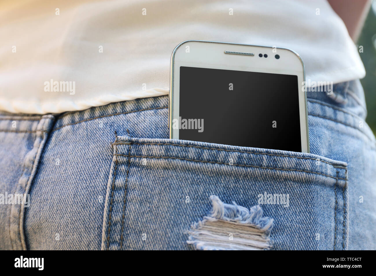 White smart mobile phone in jeans pocket Stock Photo - Alamy