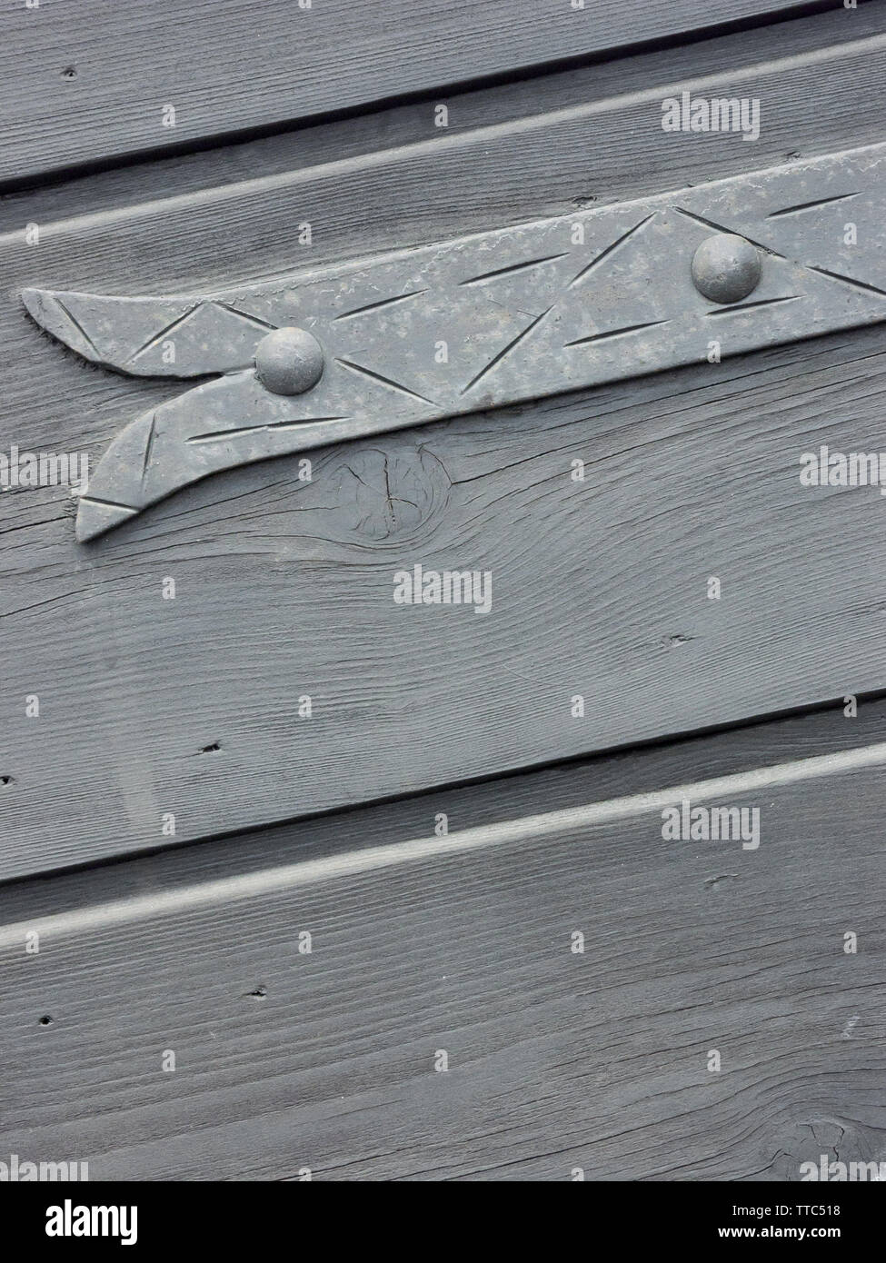 Detail of ancient door made of wooden boards of rural house, with iron ...