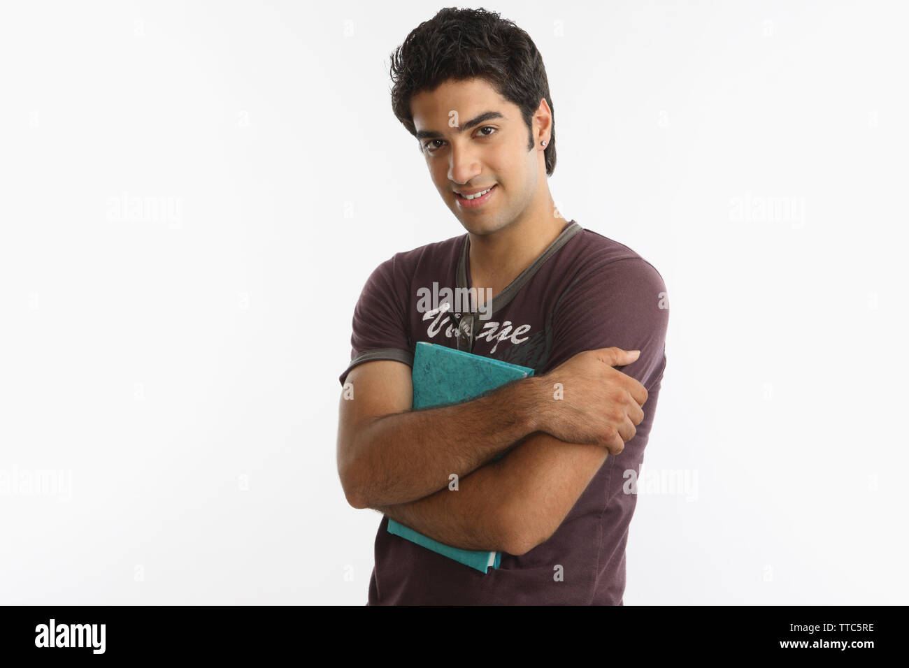 Portrait of a college student hugging a book Stock Photo - Alamy