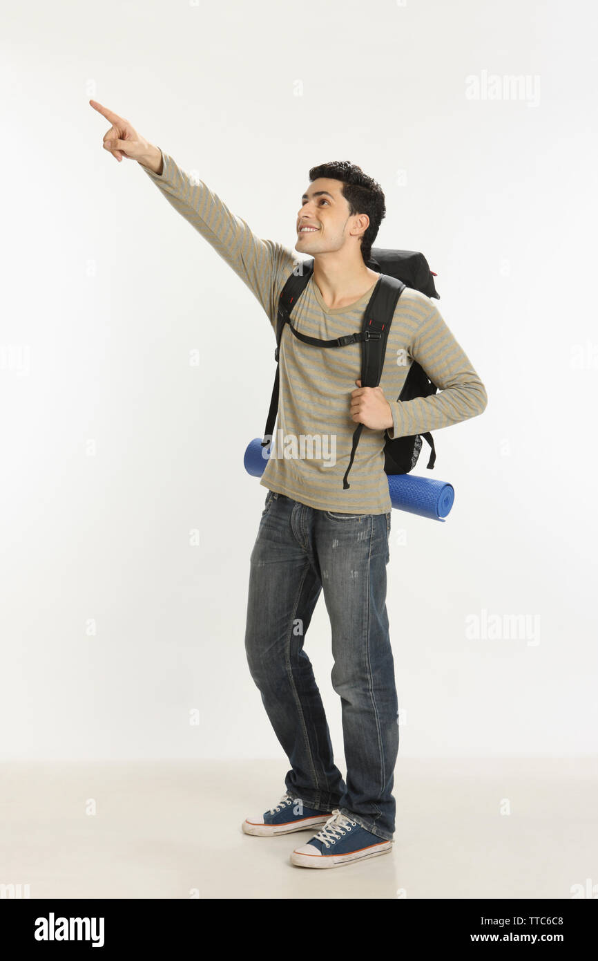 Hiker pointing upward and smiling Stock Photo - Alamy