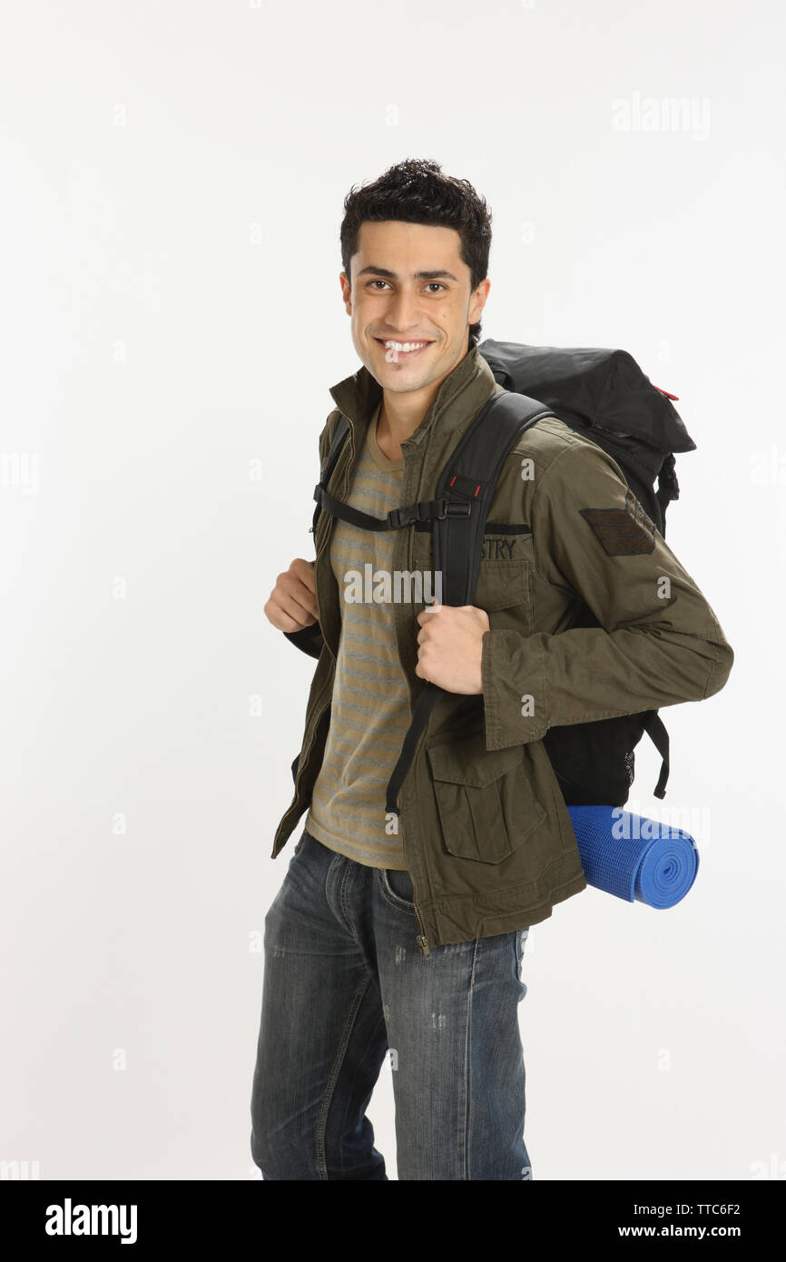 Man hiking with backpack and smiling Stock Photo - Alamy
