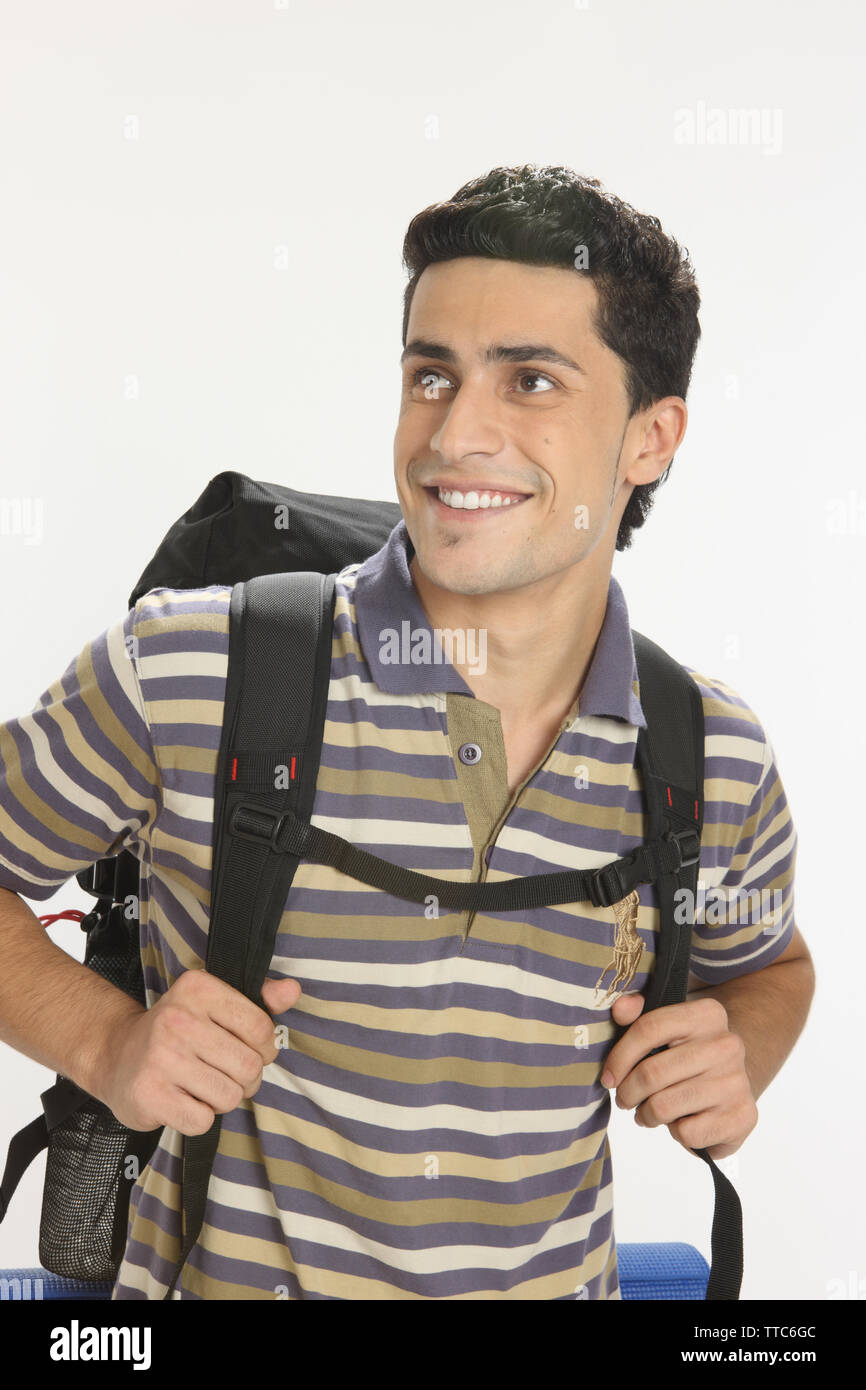Man hiking with backpack and smiling Stock Photo - Alamy