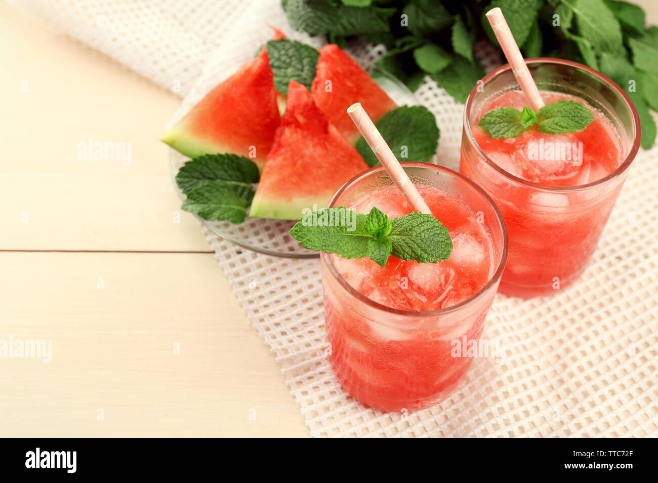 Cold watermelon desserts and drinks in glasses, on wooden table ...