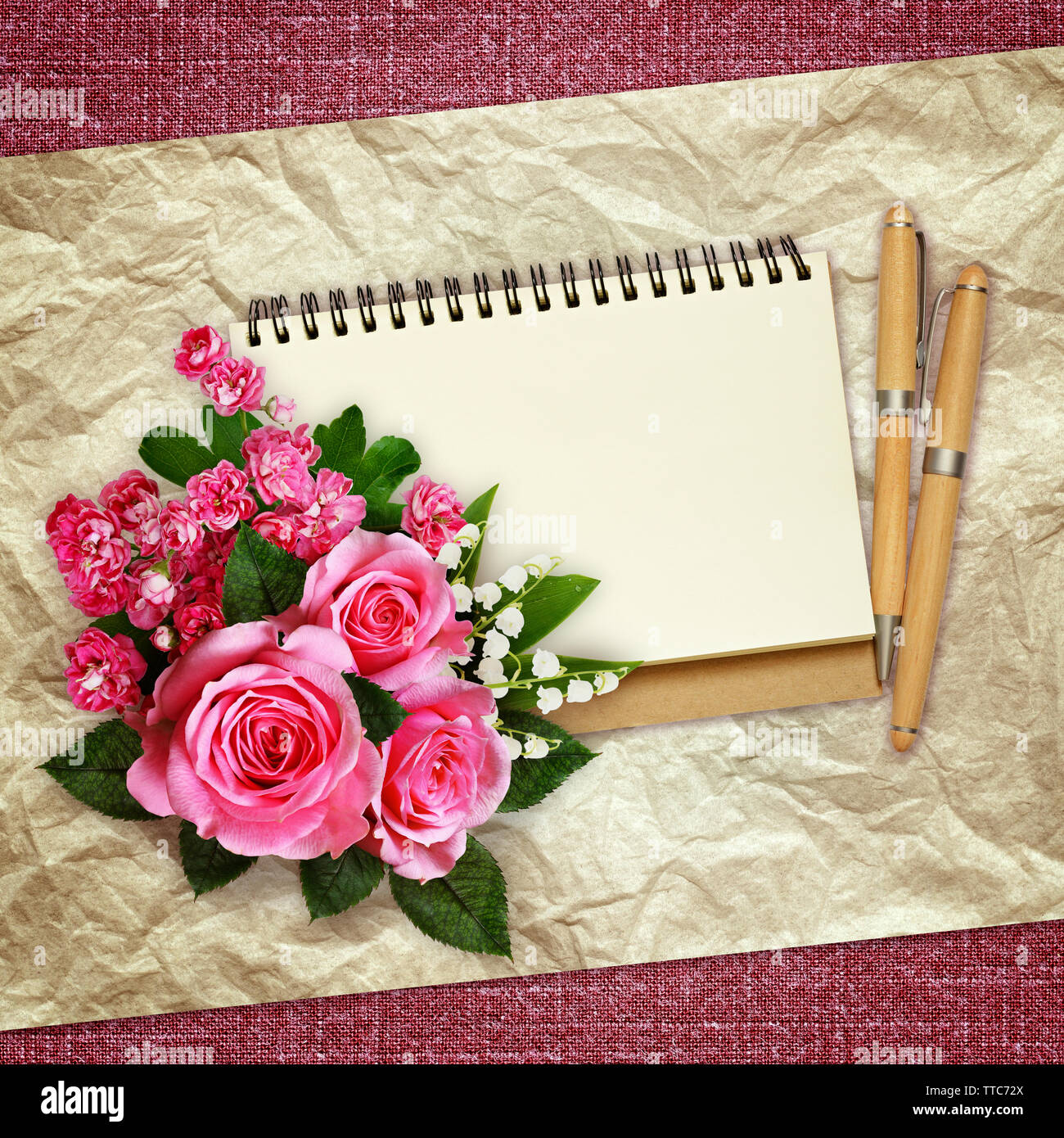 Bouquet of pink roses, lilies of the valley and hawthorn flowers with ...