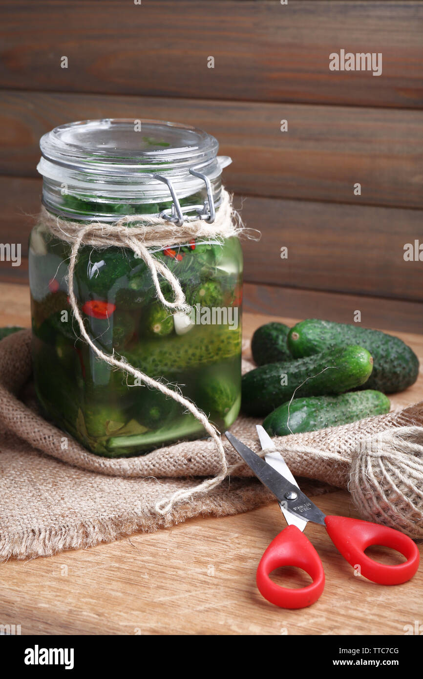 Tinned cucumbers in glass bottle on wooden table Stock Photo - Alamy