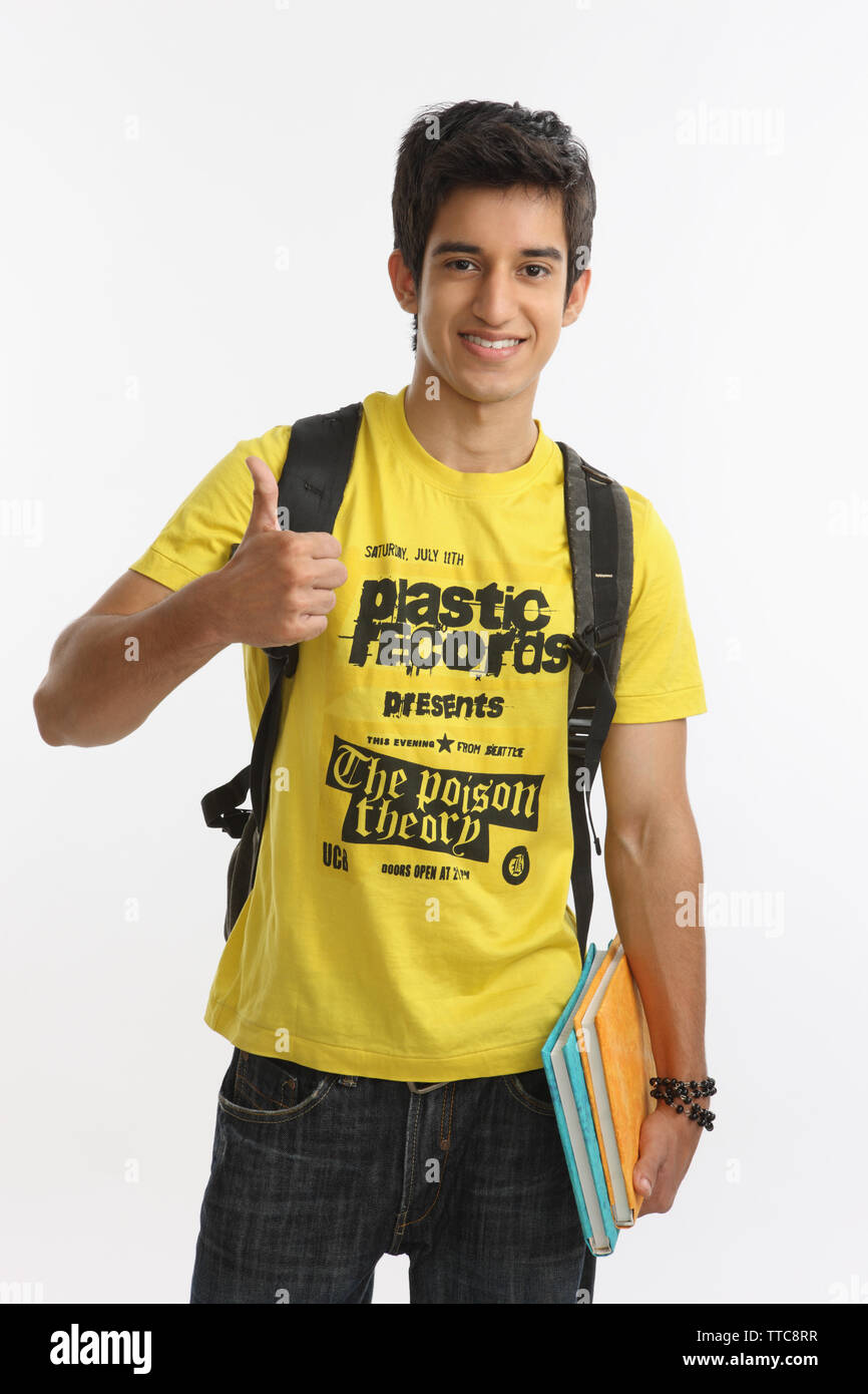 Portrait of a college student showing thumbs up and smiling Stock Photo ...