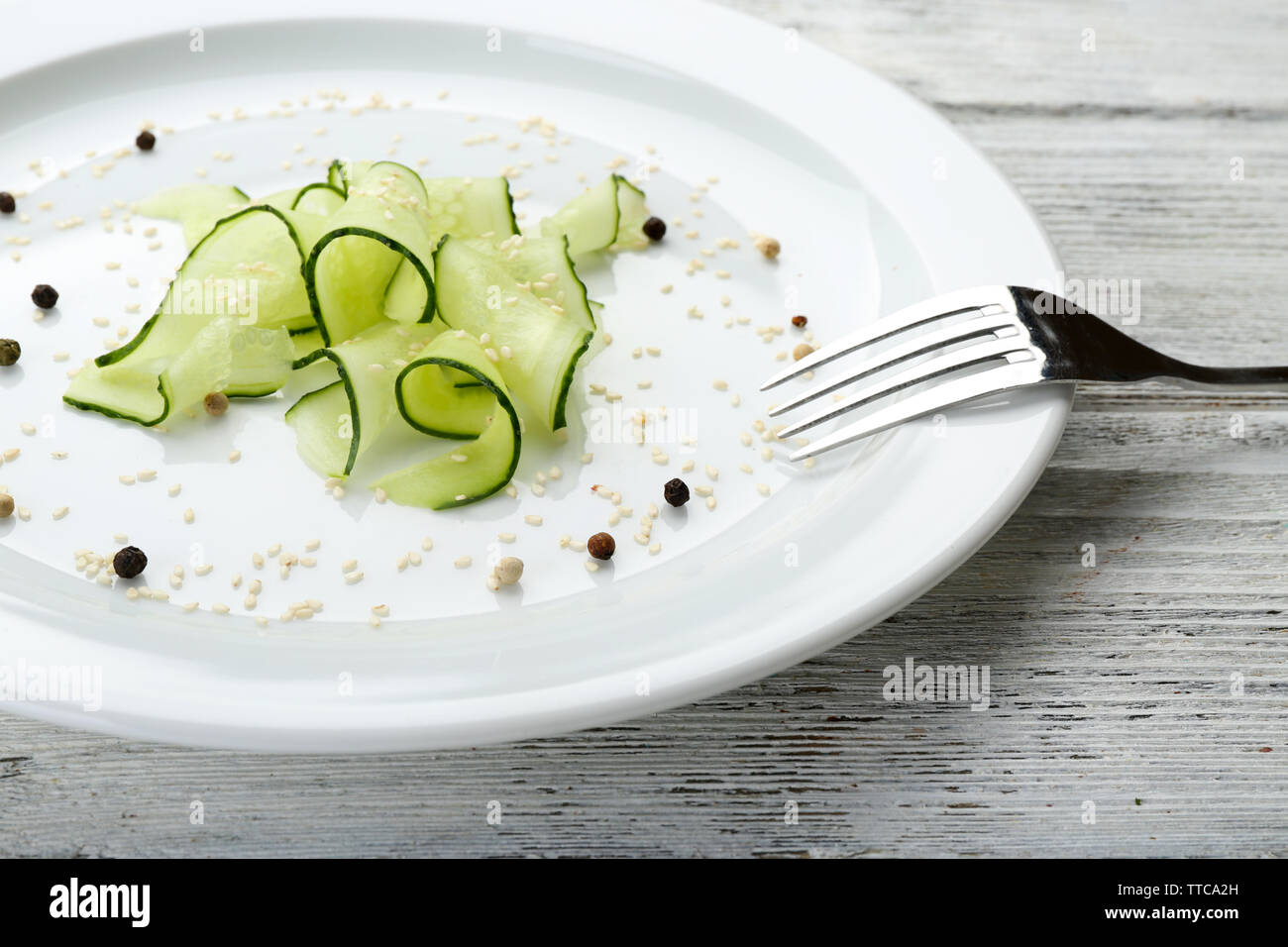Sliced cucumbers dish on white plate in the restaurant, close up Stock ...