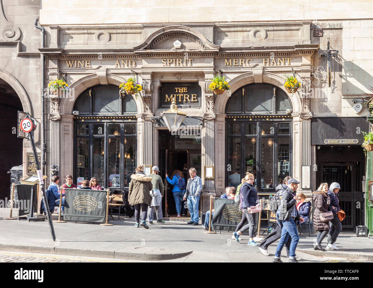 Cusomers outside and pedestrians passing the Mitre Bar, a city centre ...
