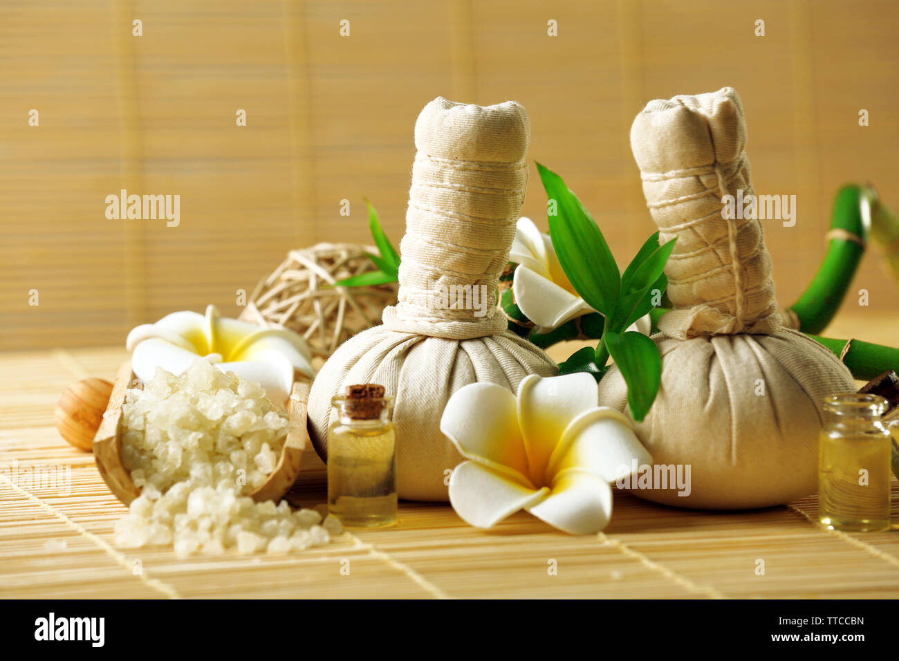 Natural spa set with massage balls, salt, aroma oil and frangipani ...