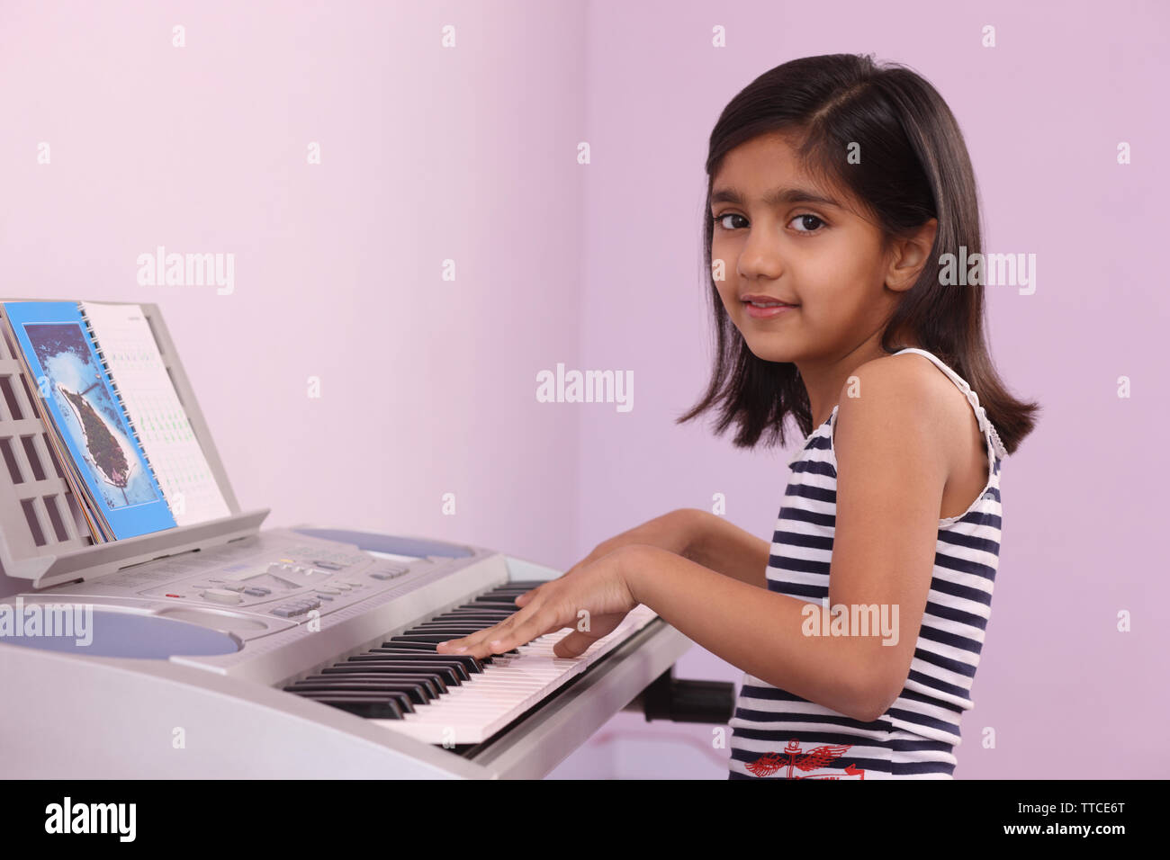 Girl playing a synthesizer Stock Photo - Alamy