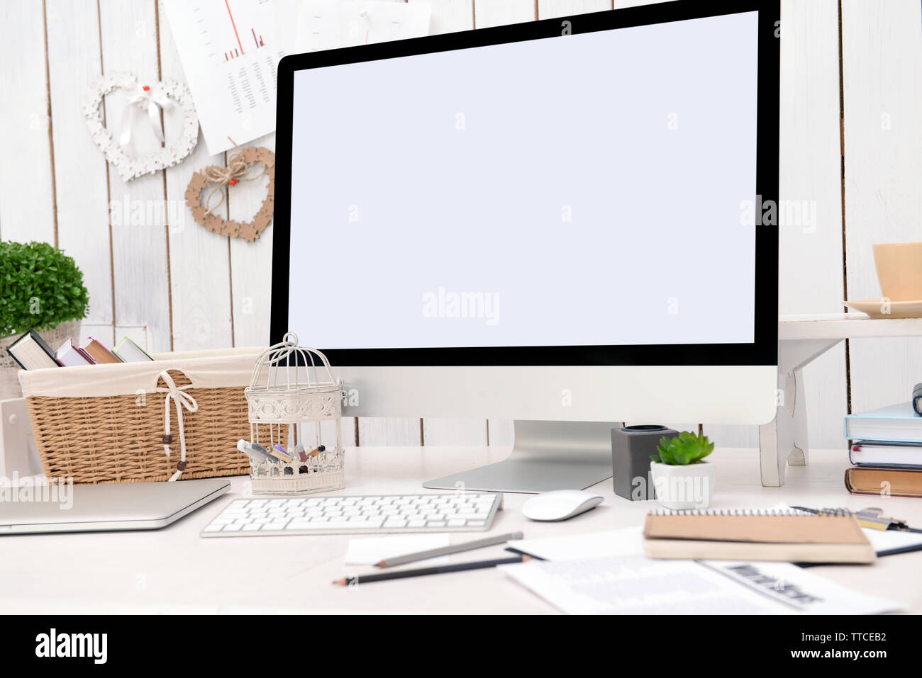 Modern computer on decorated table against wooden wall Stock Photo - Alamy