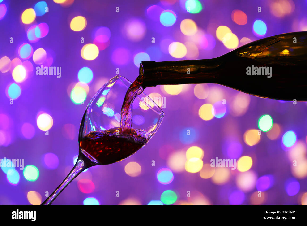 Wine pouring in glass on bright background Stock Photo - Alamy