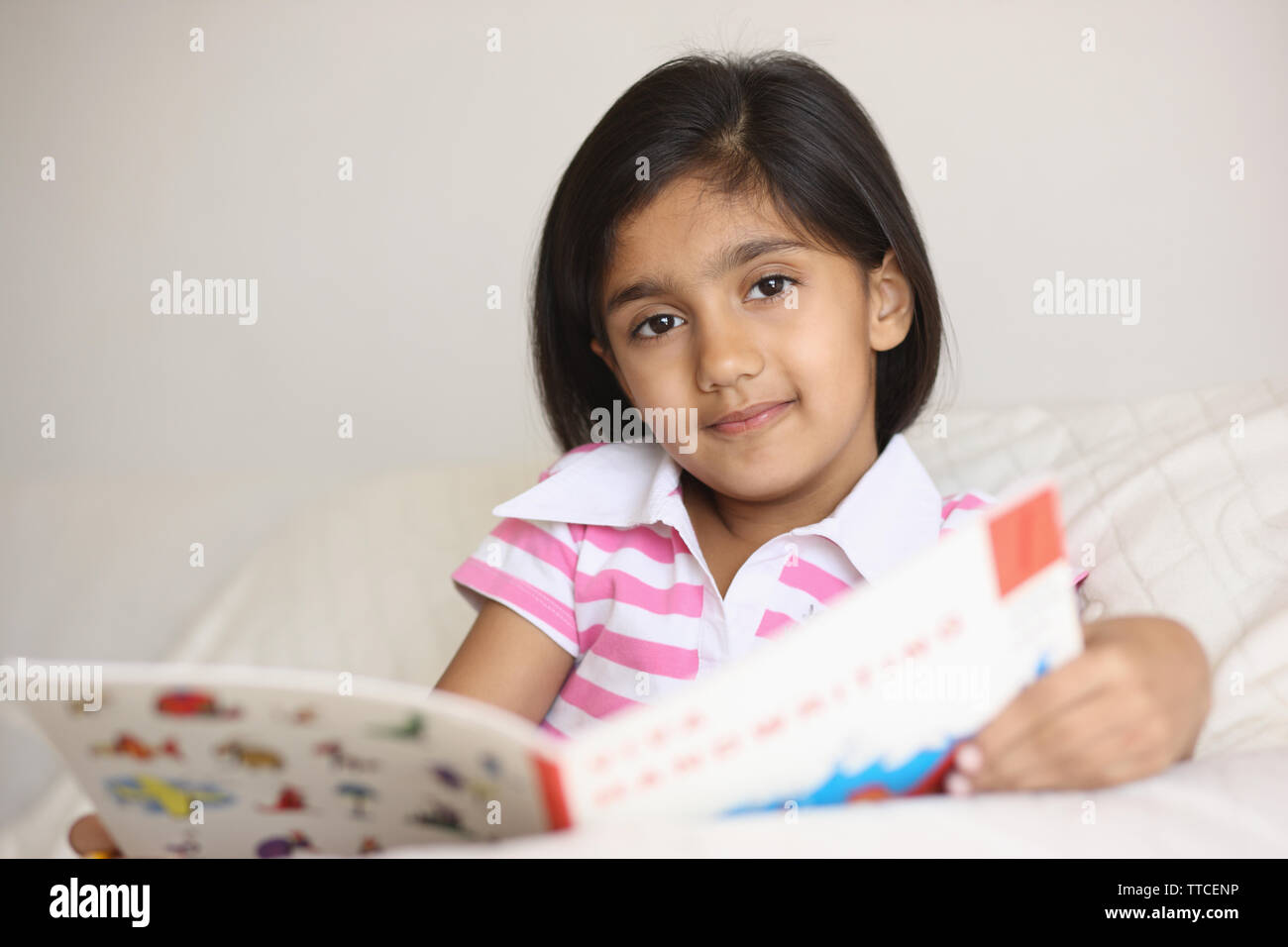 Girl reading a book Stock Photo - Alamy