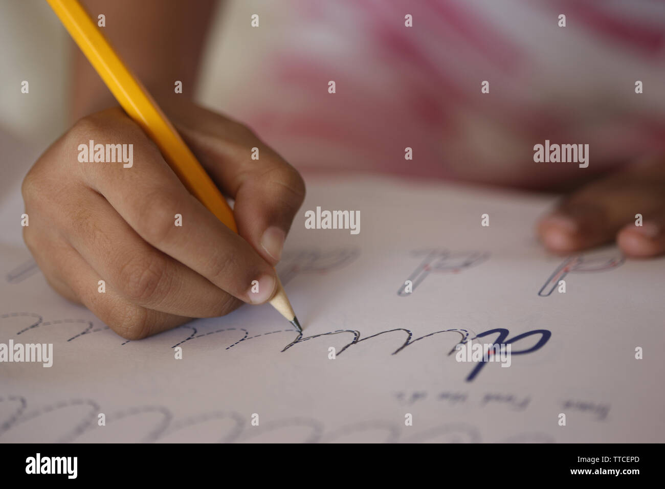 Girl hand writing in a workbook Stock Photo - Alamy