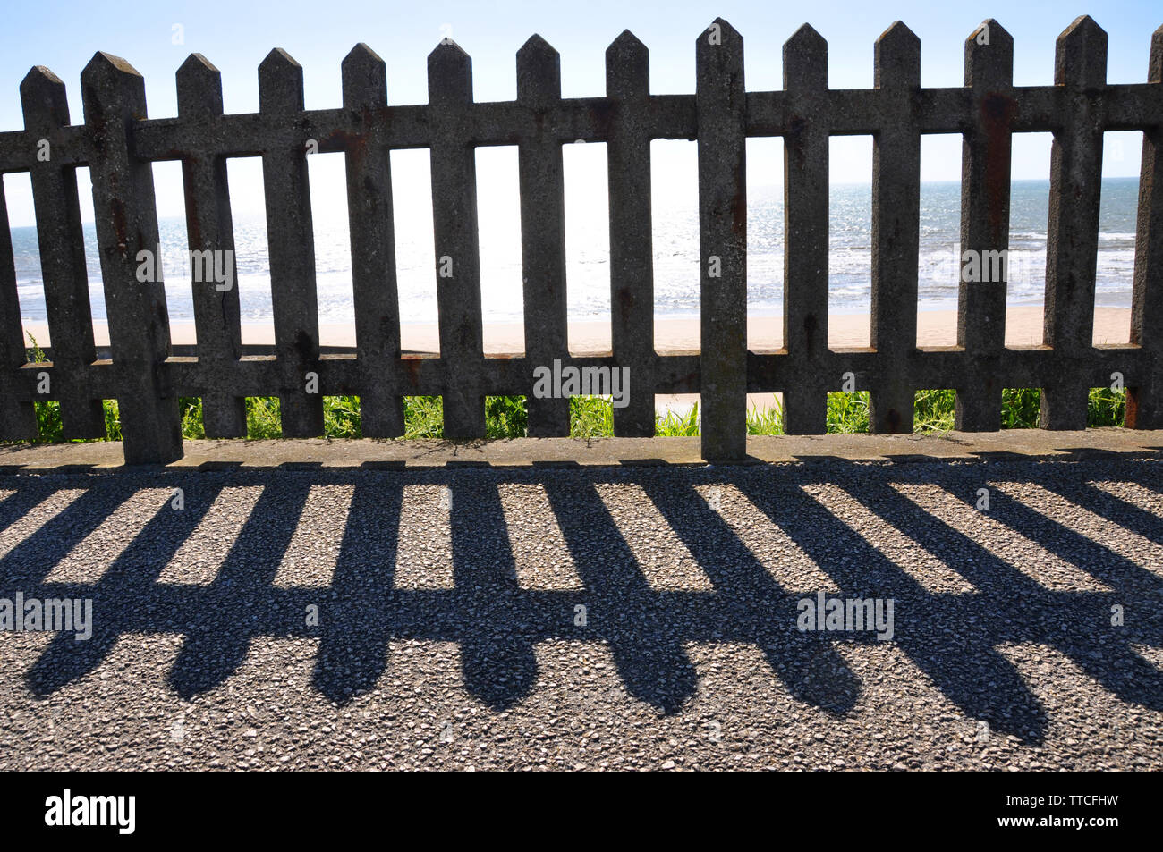 Backlit concrete fenceposts, Blackpool promenade Stock Photo - Alamy