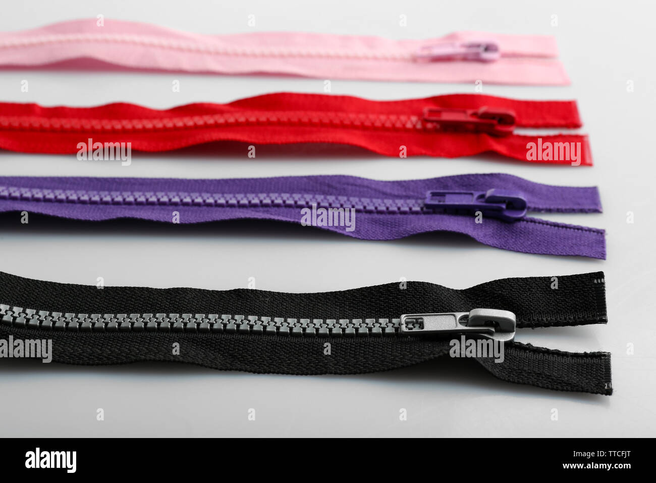 Colourful collection of zippers isolated on white Stock Photo - Alamy
