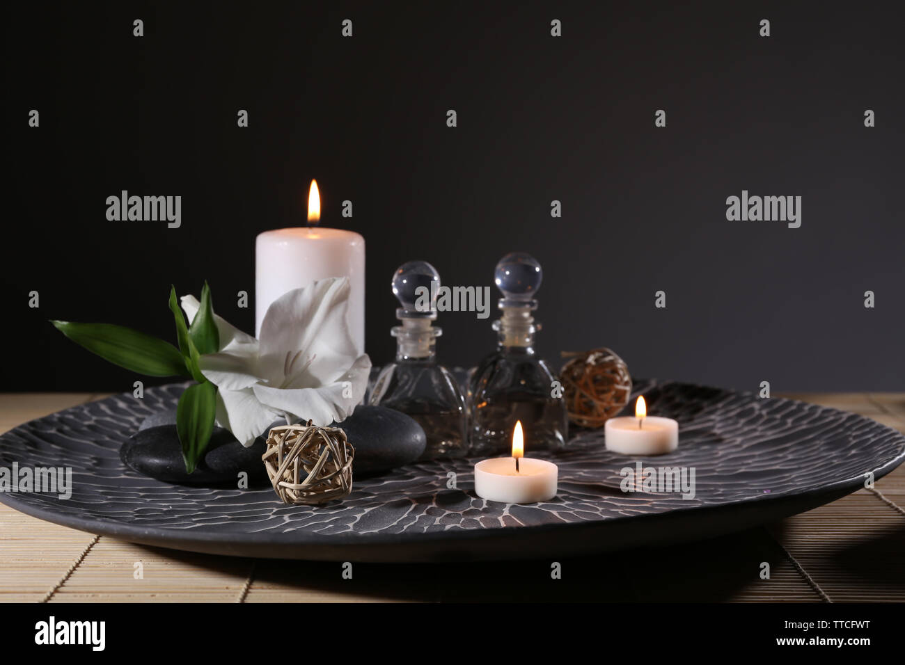 Beautiful spa composition in a bowl on dark background Stock Photo - Alamy