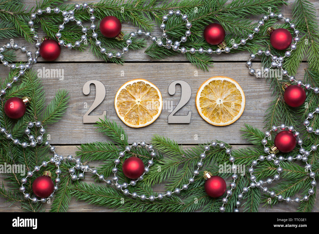 2020 New year rustic background with orange slices, fir tree branches ...