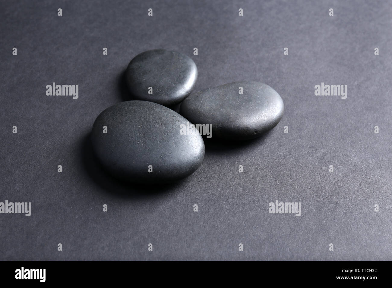 Group of pebbles on dark background Stock Photo - Alamy