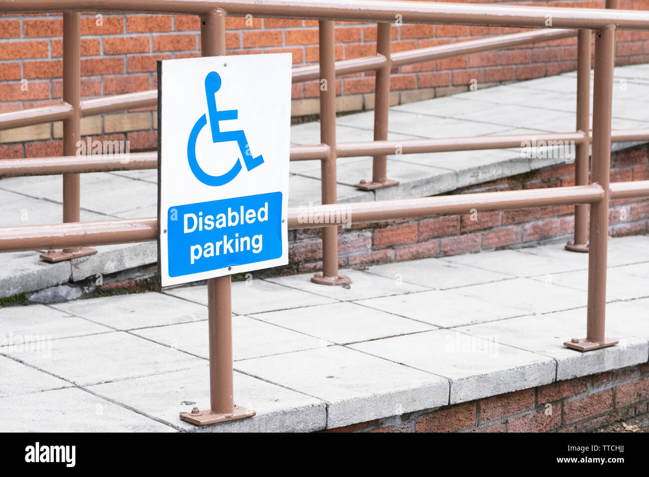 Disabled blue sign and ramp rails accessible entrance Stock Photo - Alamy