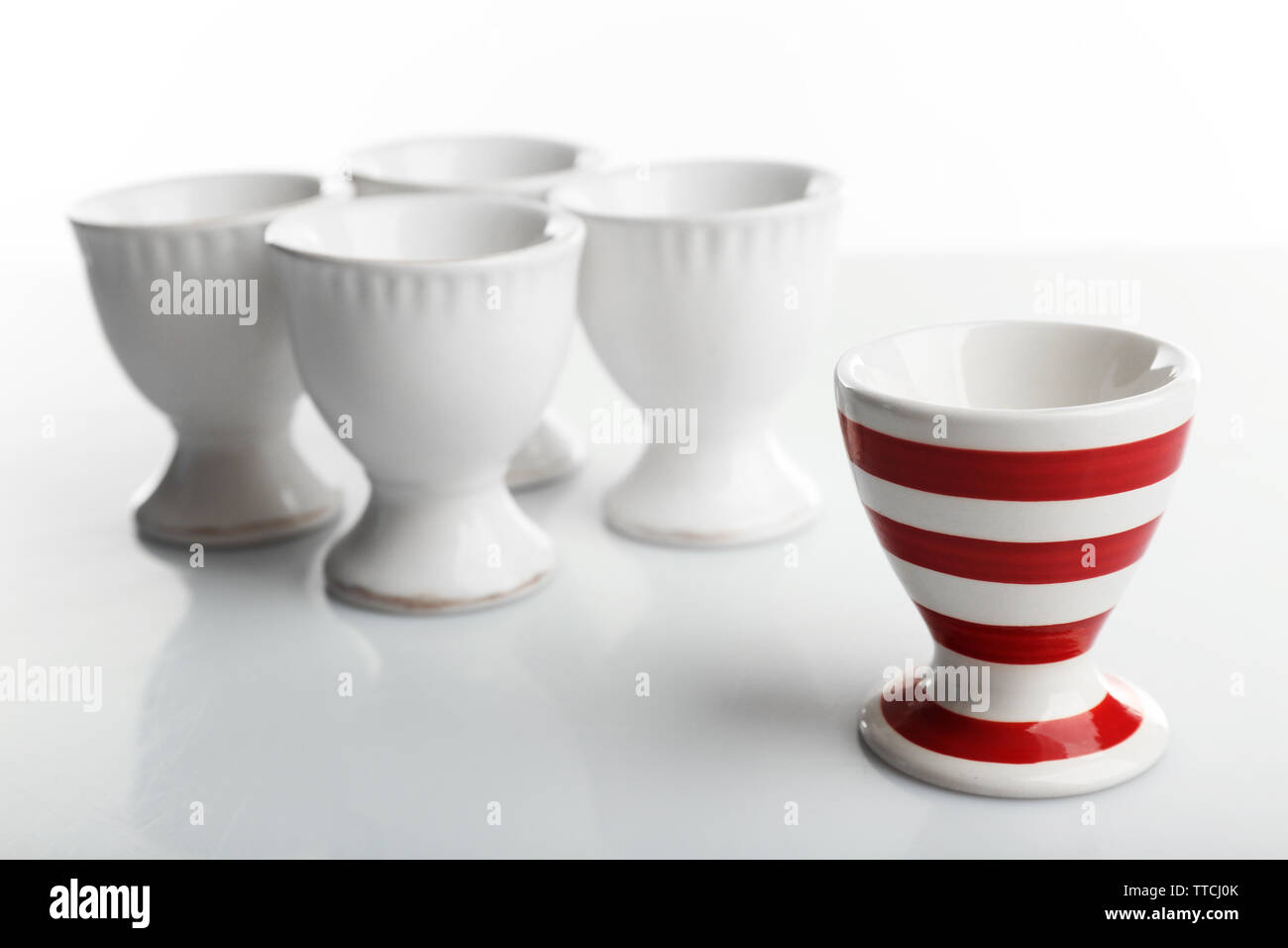 Red and White stripe egg cups, isolated on white Stock Photo - Alamy