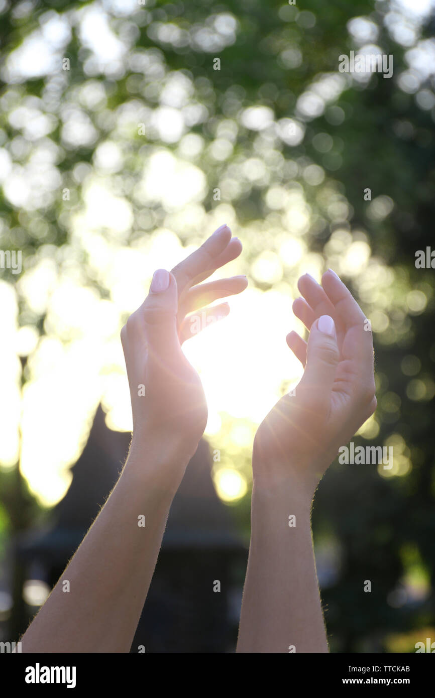 Hands on sunlight background Stock Photo - Alamy