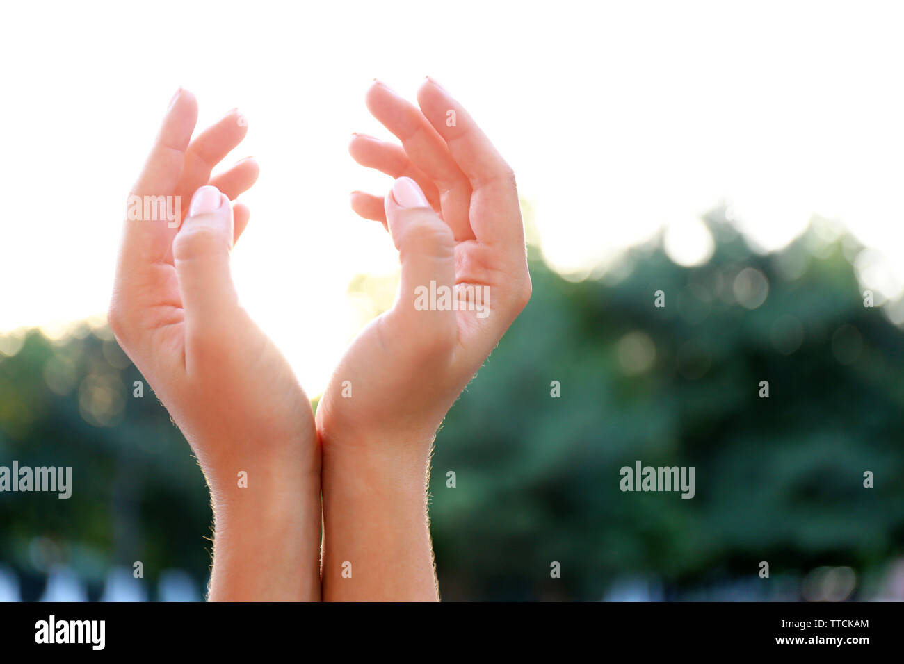 Hands on sunlight background Stock Photo - Alamy