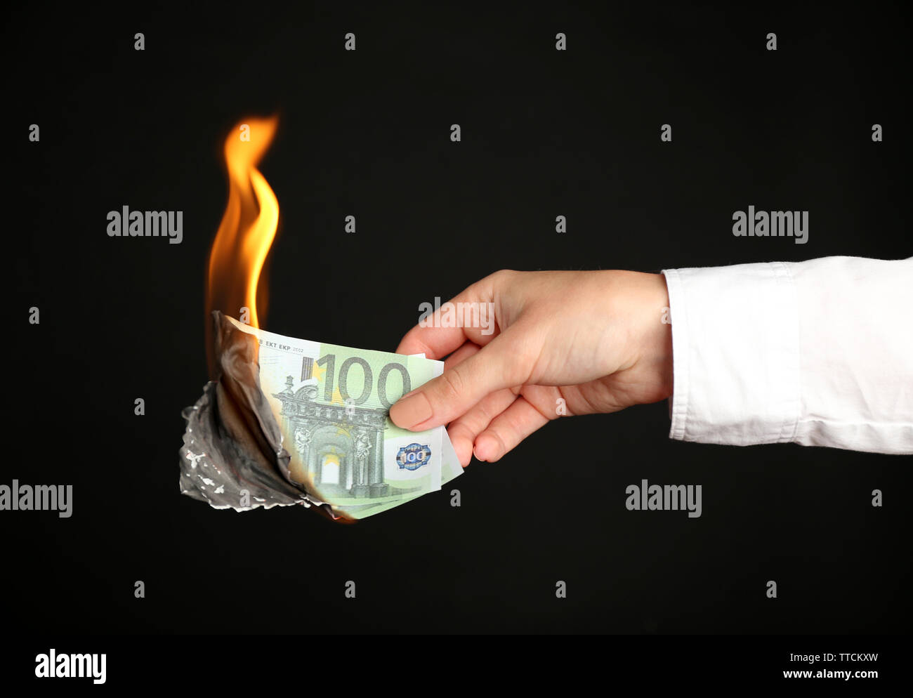 Woman burning Euros banknotes on black background Stock Photo - Alamy