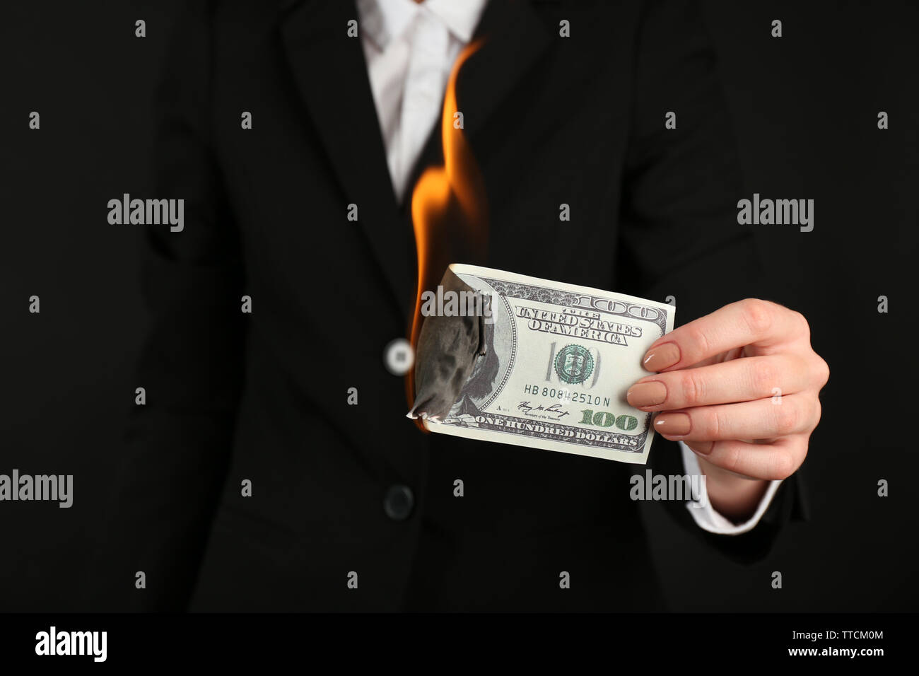 Woman burning money hi-res stock photography and images - Alamy