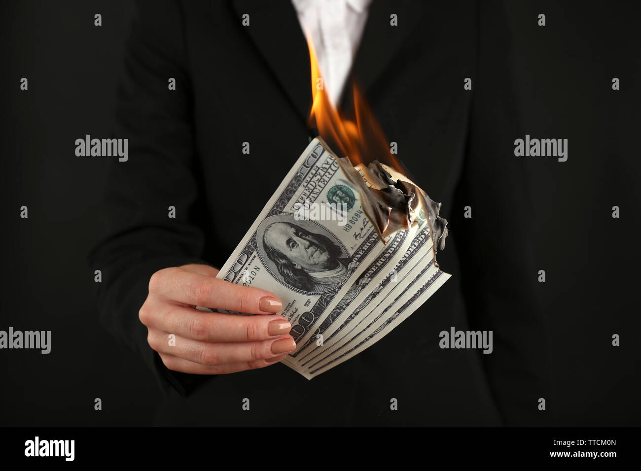Woman burning money hi-res stock photography and images - Alamy