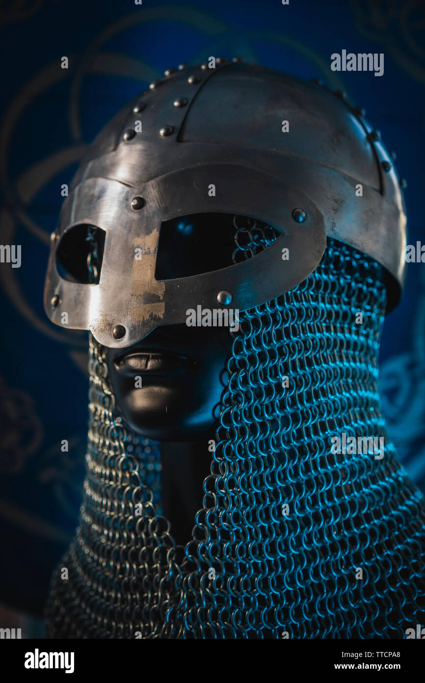 Soldier Viking helmet with chain mail of iron on red shield of wood and ...