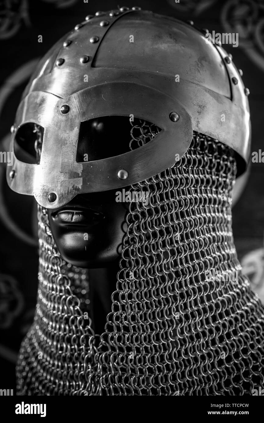 Soldier Viking helmet with chain mail of iron on red shield of wood and ...