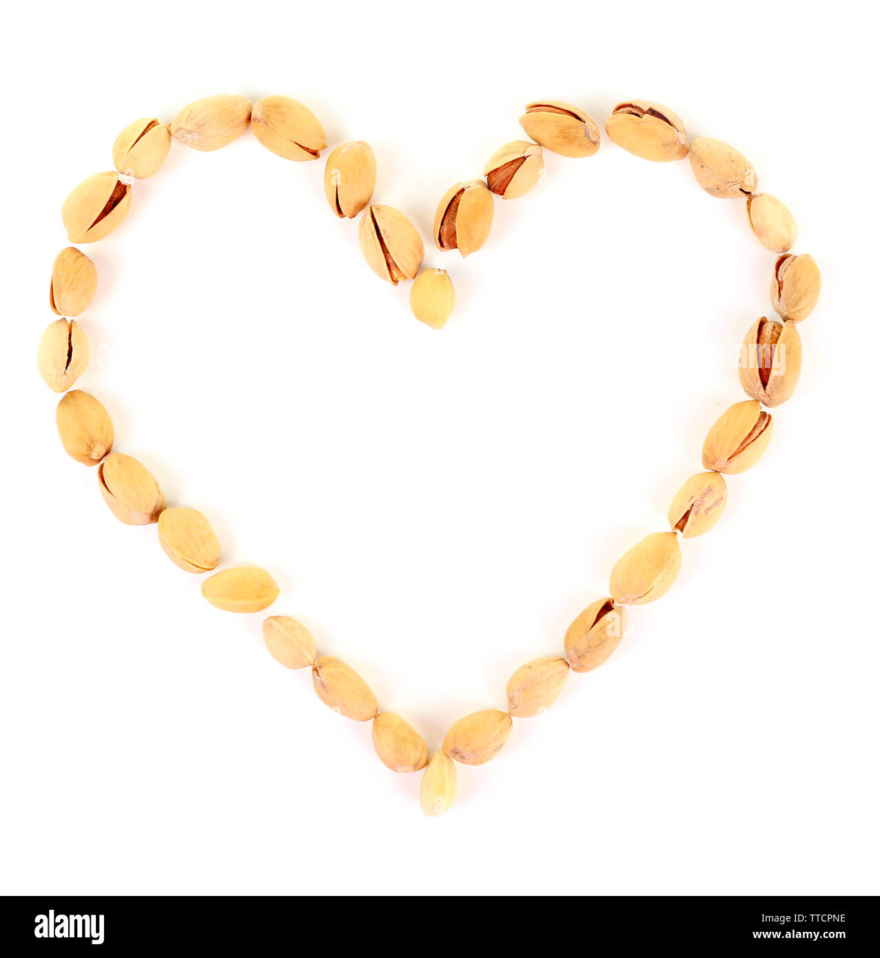 Heart shaped peanuts isolated on white Stock Photo - Alamy